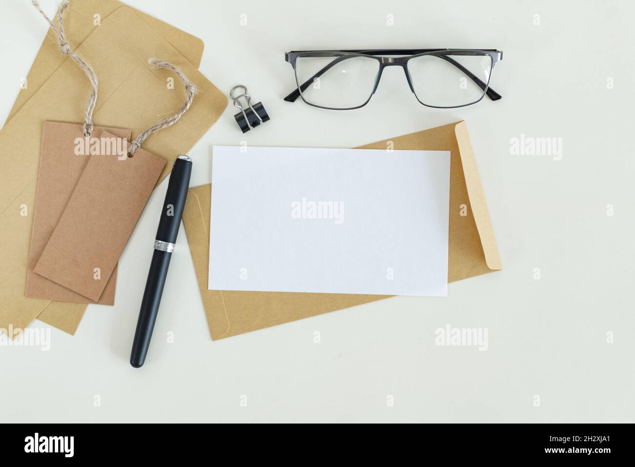 An overhead view of business objects in a workplace with a blank paper ...