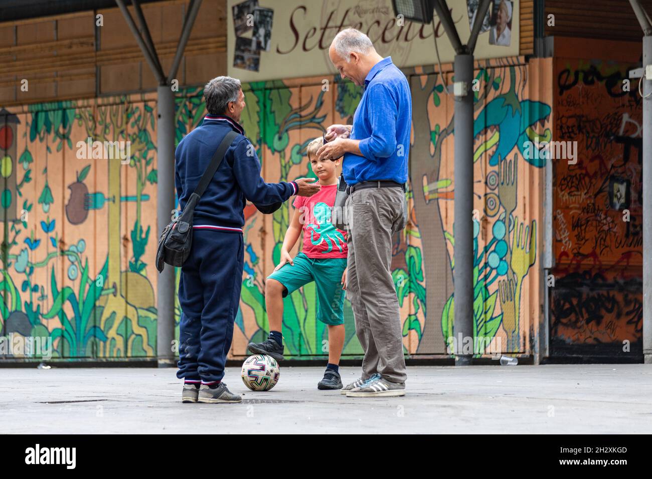 Middle-aged man giving money to a beggarman in Trastevere district of ...