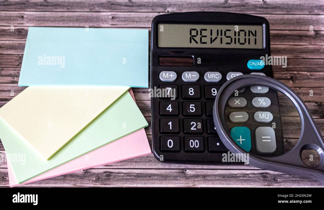 Revision, text on the calculator. Magnifier and stickers on wooden ...