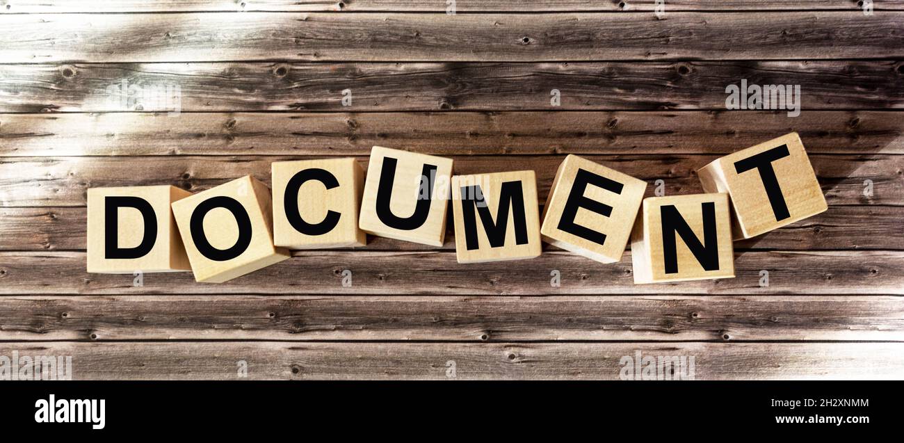 The word Document written on a wooden block. Blocks lie on a wooden ...