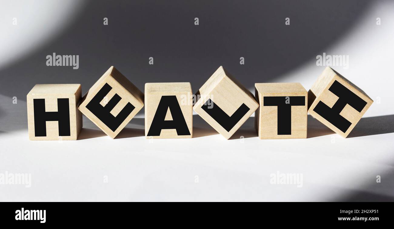 Wooden blocks with text health on white background Stock Photo - Alamy