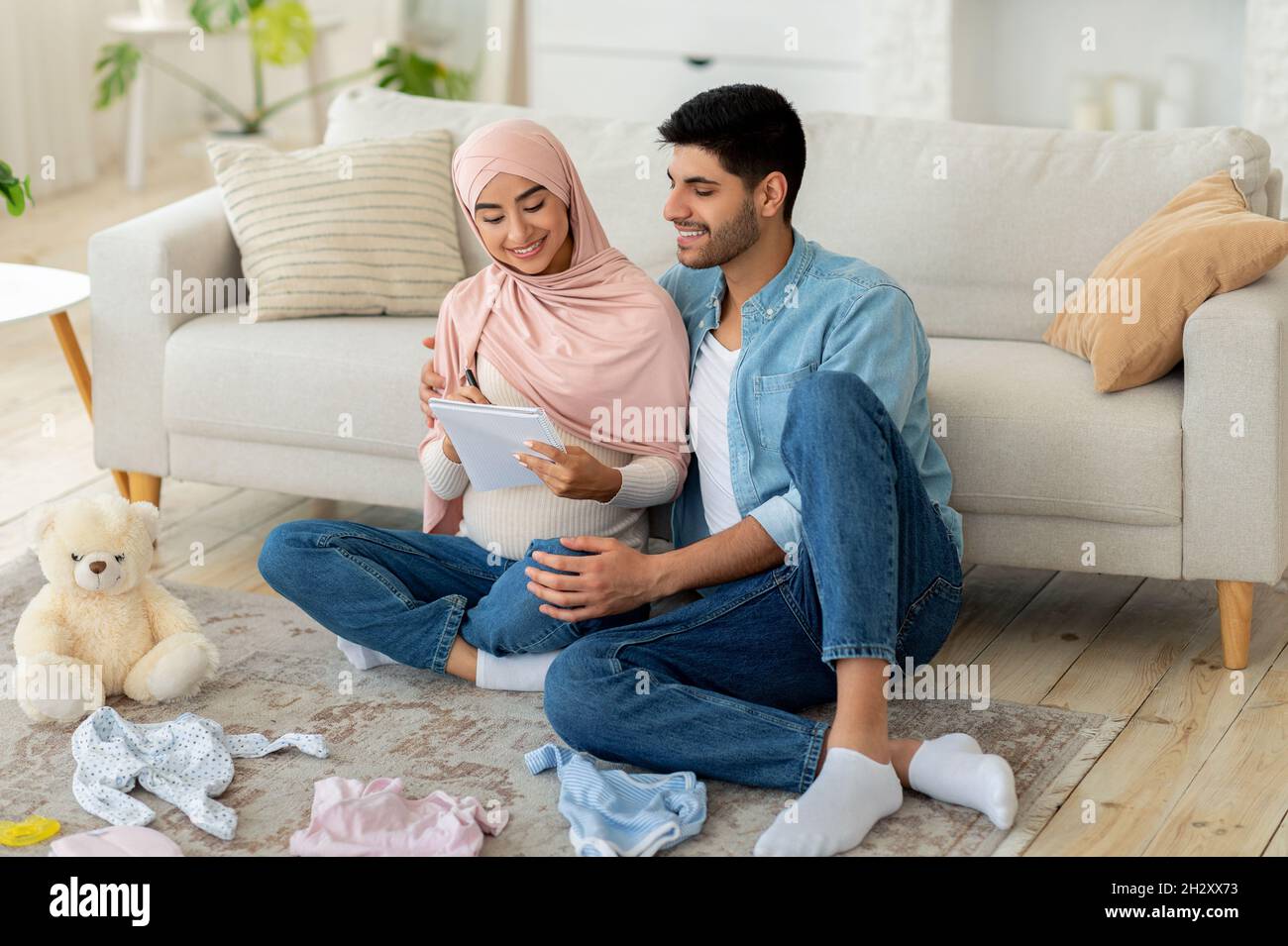 Loving pregnant muslim couple getting ready for childbirth, making ...
