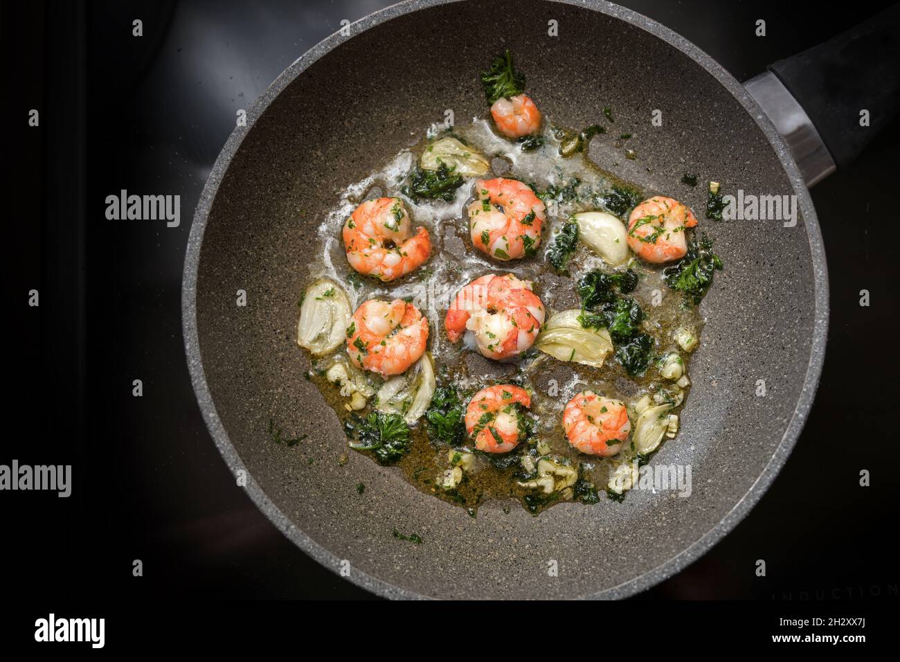 Frying pan with shrimps or black tiger prawns sauteed with olive oil ...