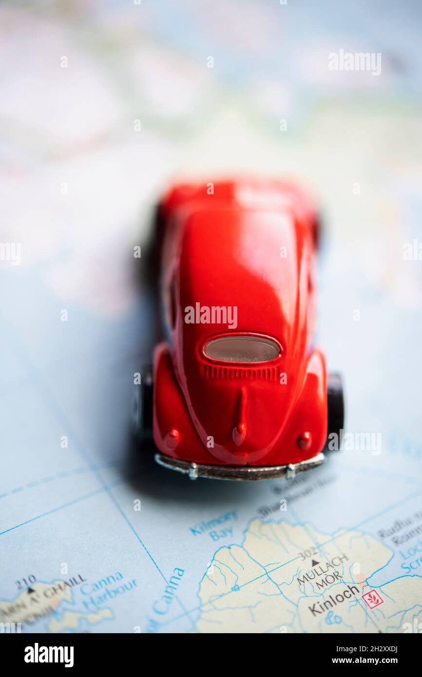Toy car on a road map Stock Photo - Alamy