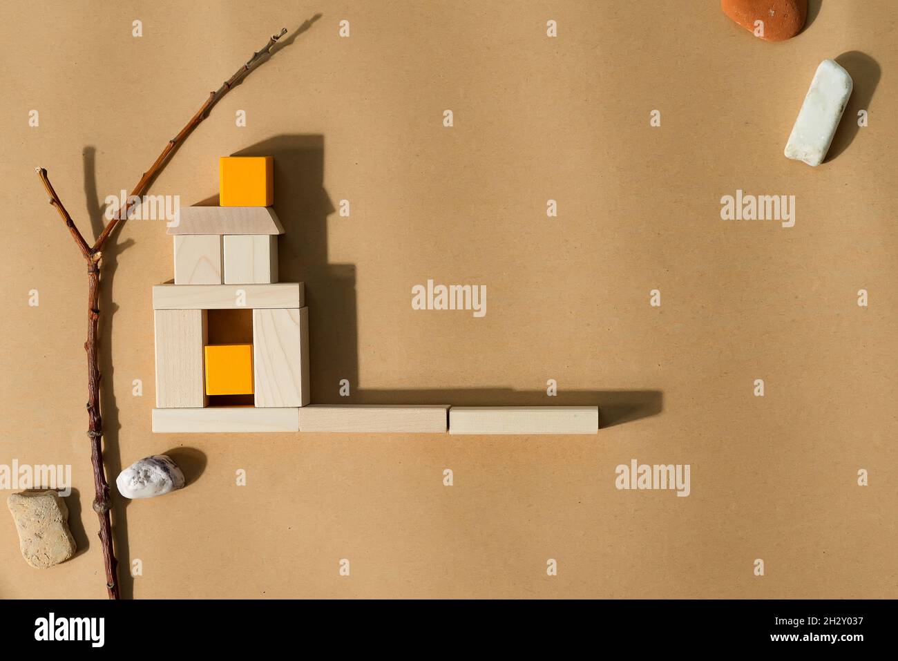 Construction of house from wooden blocks with shadows Stock Photo - Alamy