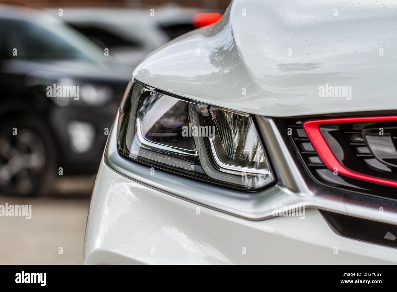 Headlight lamp of new car. Close up detail on one of the LED headlights ...