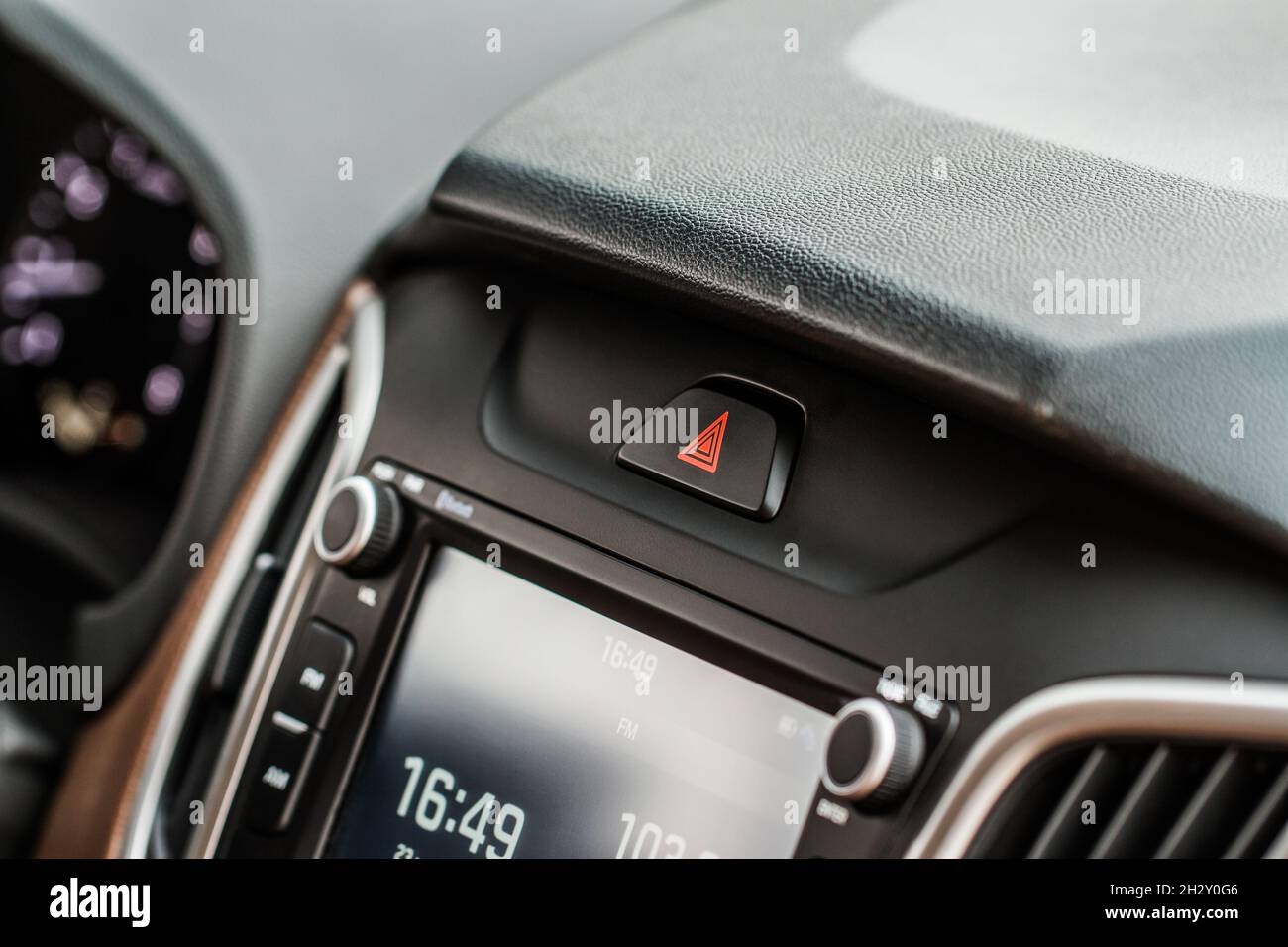 Red triangle hazard light button on car dashboard. Car media buttons ...