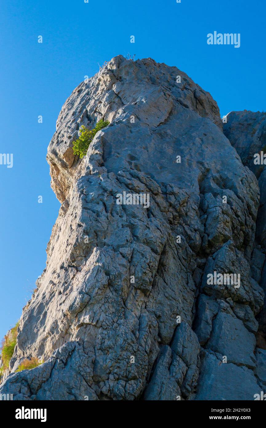 Cliff in sunshine and blue skies Stock Photo - Alamy