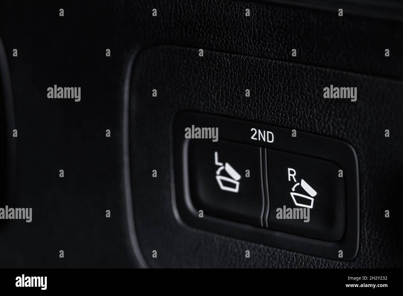 Folding second row seat button Stock Photo - Alamy