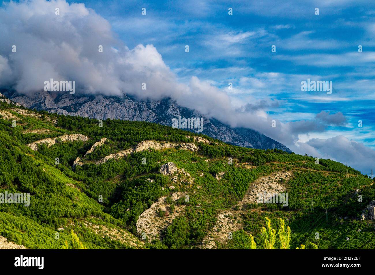 Mountain in greenery and some cliffs Stock Photo - Alamy