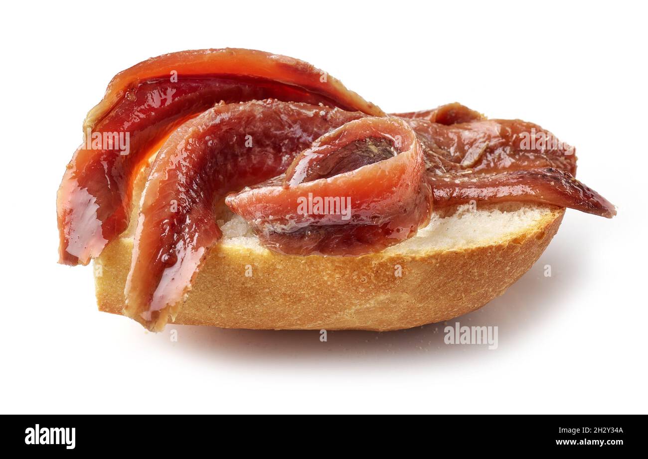 canned anchovy fillets on slice of bread isolated on white background ...
