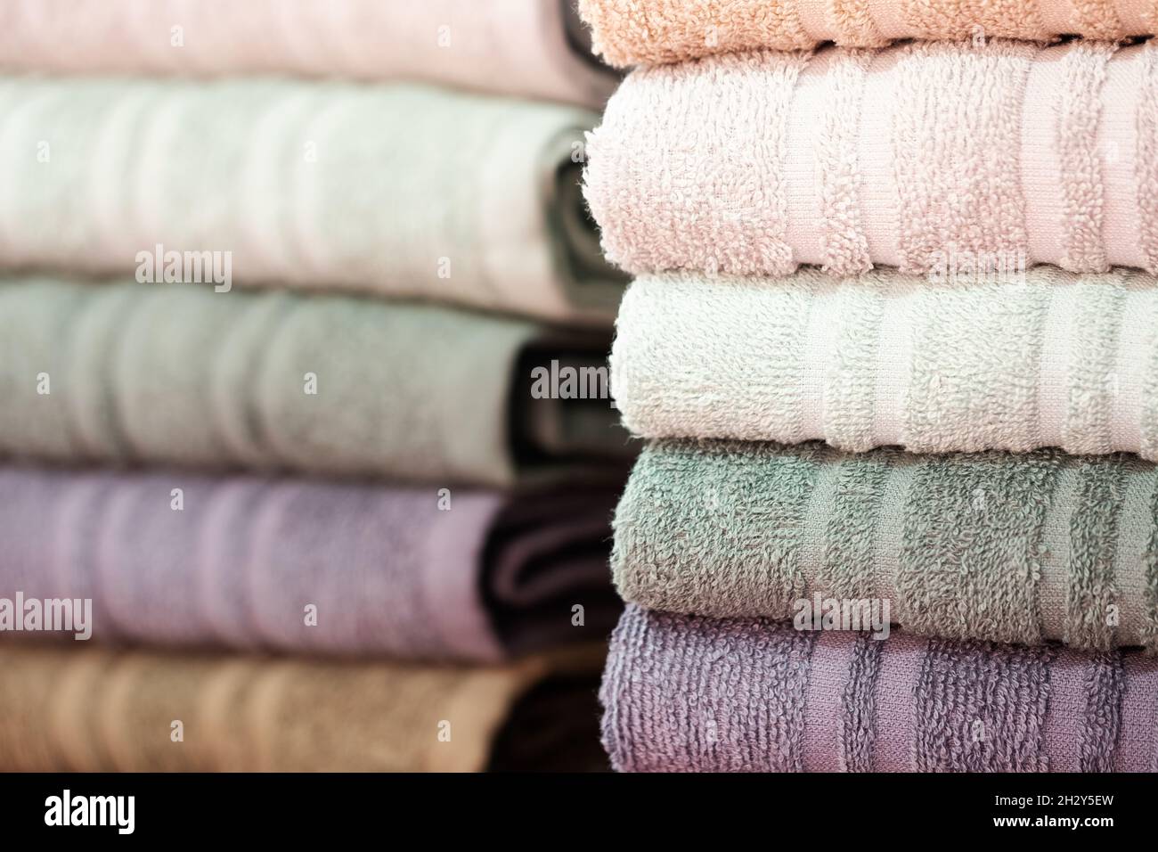 Colorful folded towels stack closeup picture Stock Photo - Alamy