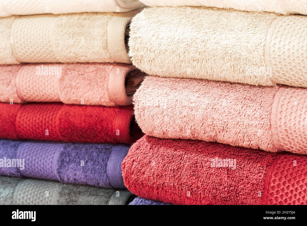 Colorful folded towels stack closeup picture Stock Photo - Alamy