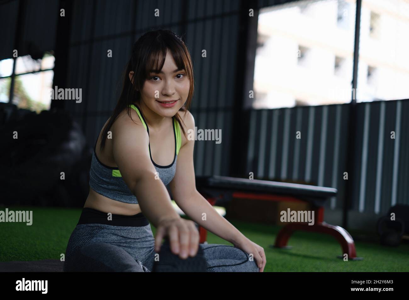 Sport woman warm up before exercise in fitness gym. Portrait sport and ...