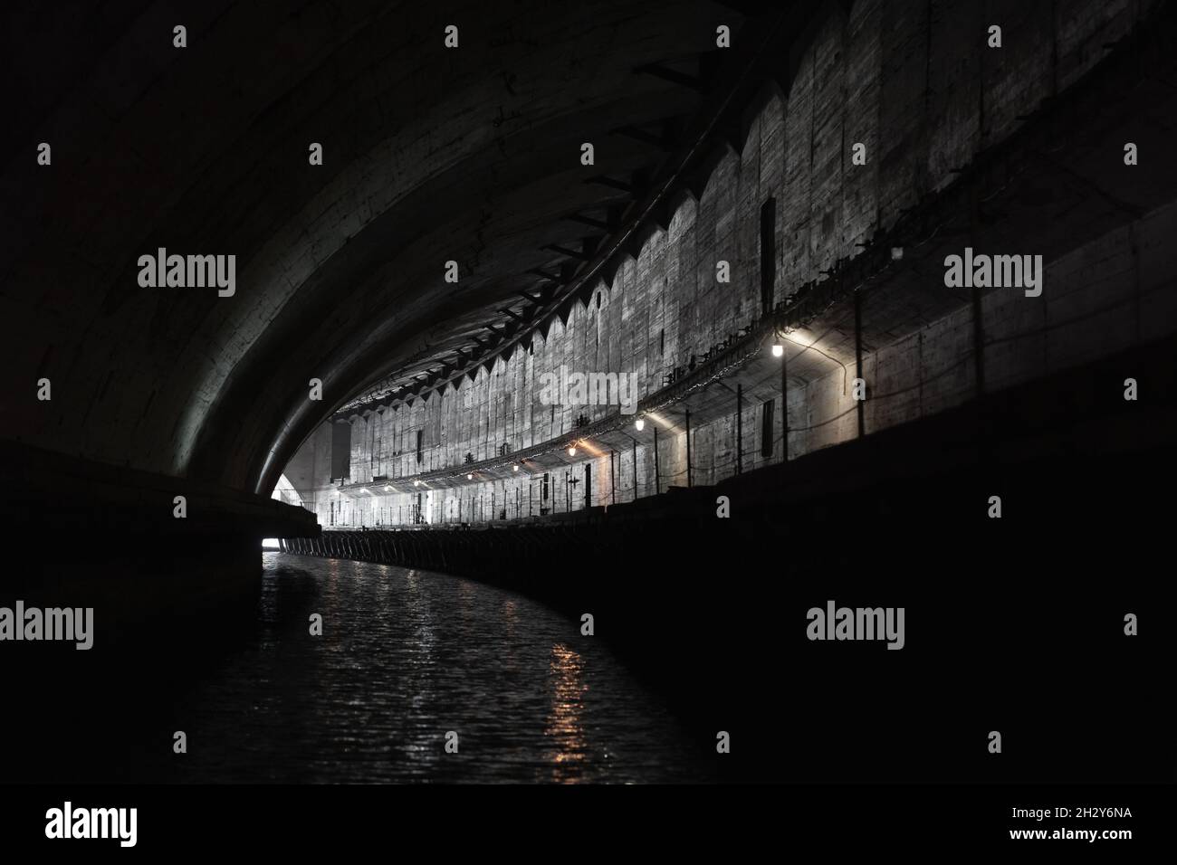 Industrial concrete tunnel perspective. Aandoned underground submarine ...