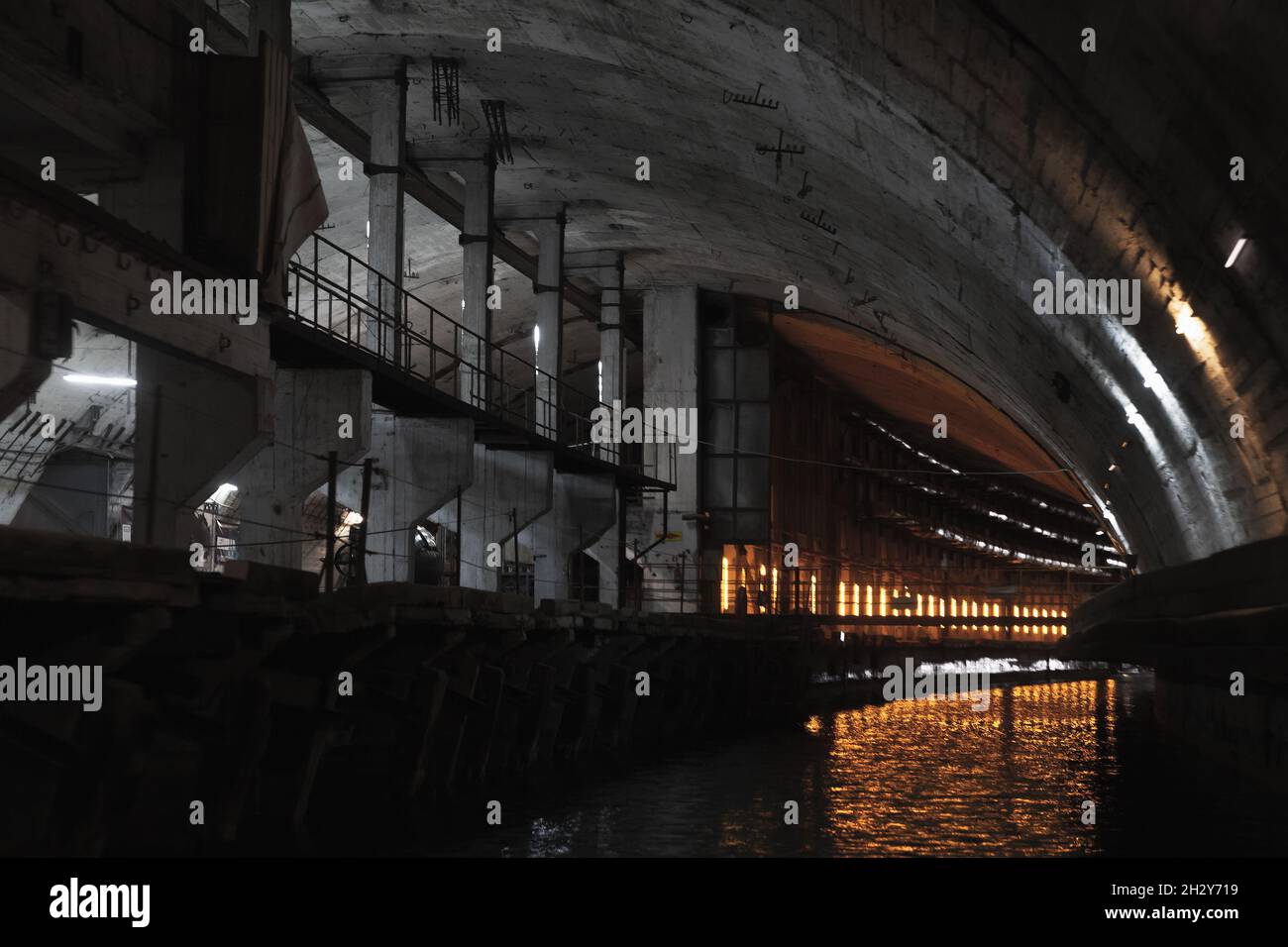 Illuminated industrial concrete tunnel perspective, abandoned ...