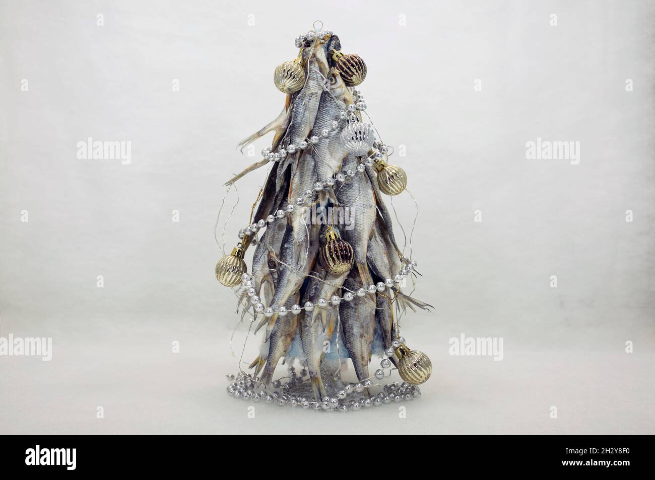 This Christmas tree is made of dried fish. The tree is decorated with ...