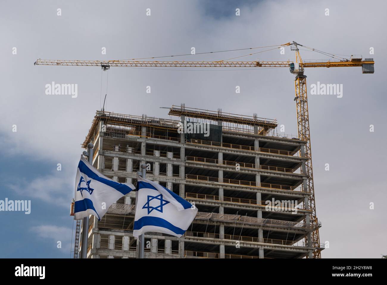 National Israeli flag in the background of Construction site. The ...