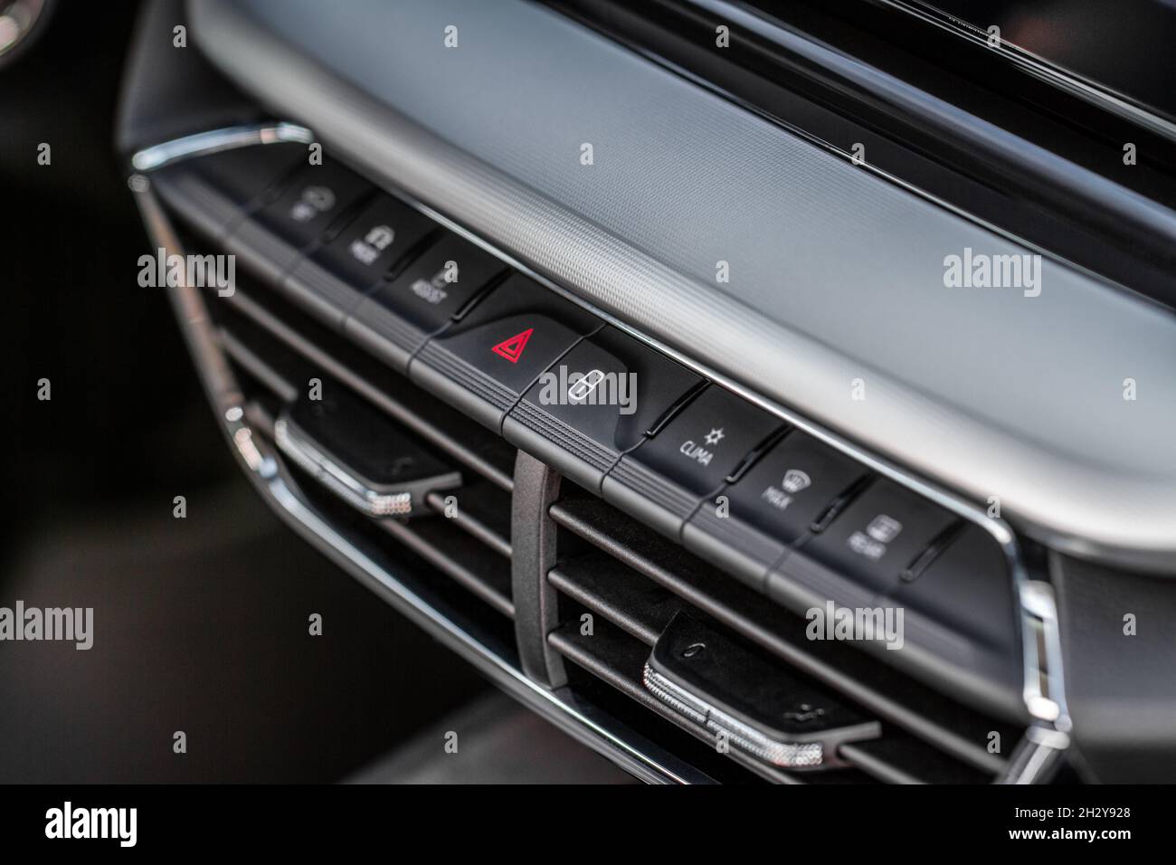 Red triangle hazard light button on car dashboard. Car media buttons ...