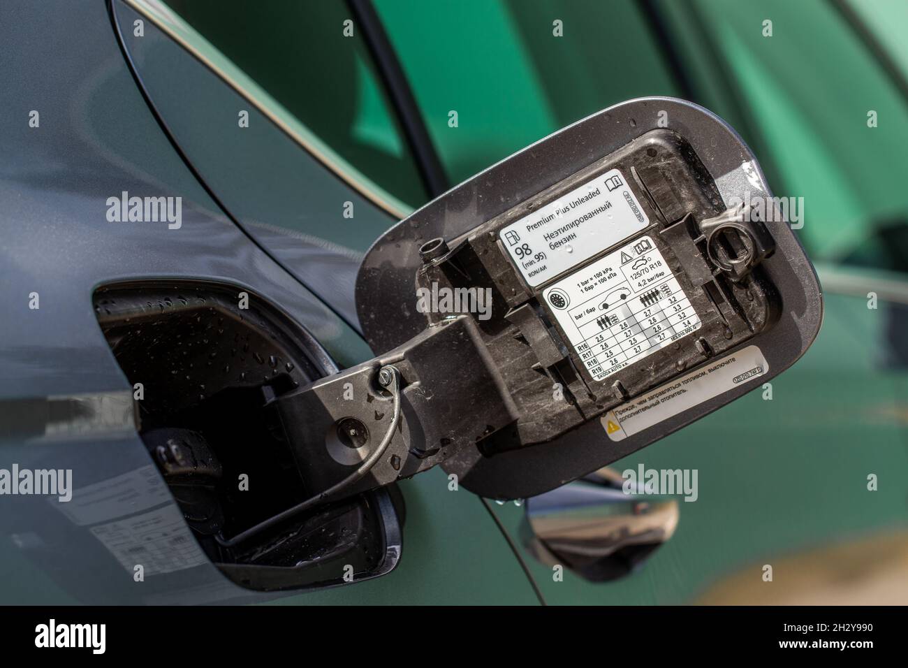Exterior of car with fuel filler door open. Opened fuel tank cap of a ...