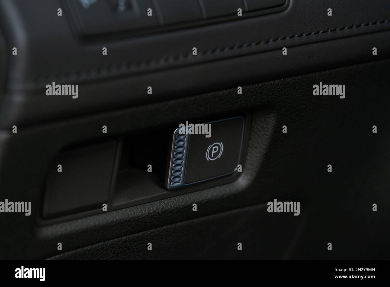 Electric handbrake button of modern car. Modern parking brake close up ...