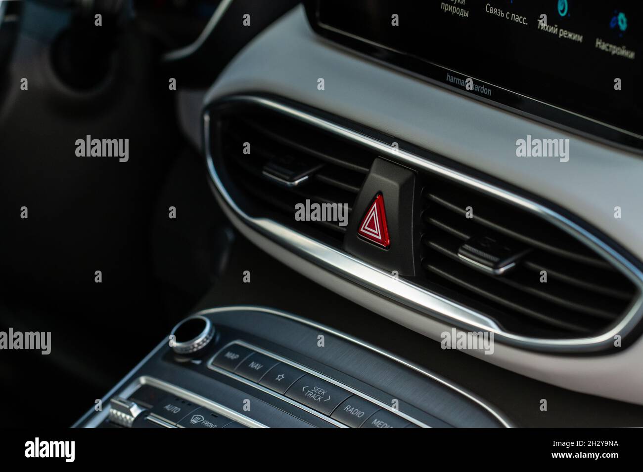 Red triangle hazard light button on car dashboard. Car media buttons ...