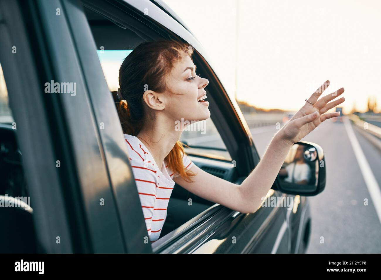 Cheerful woman in car trip journey road Stock Photo - Alamy