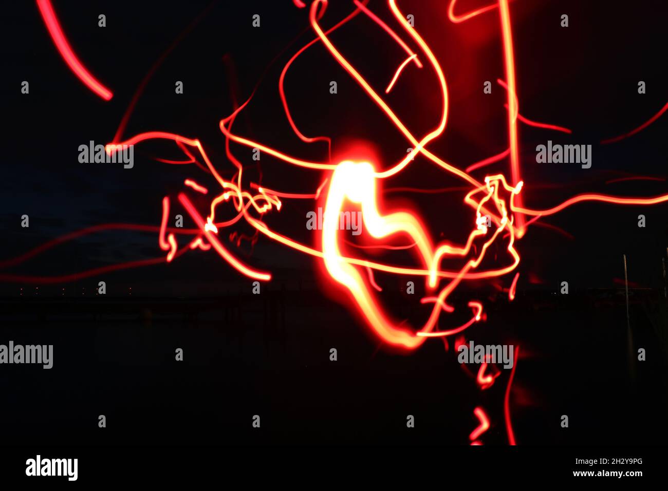 A texture of chaotic red neon lights in the black background Stock ...