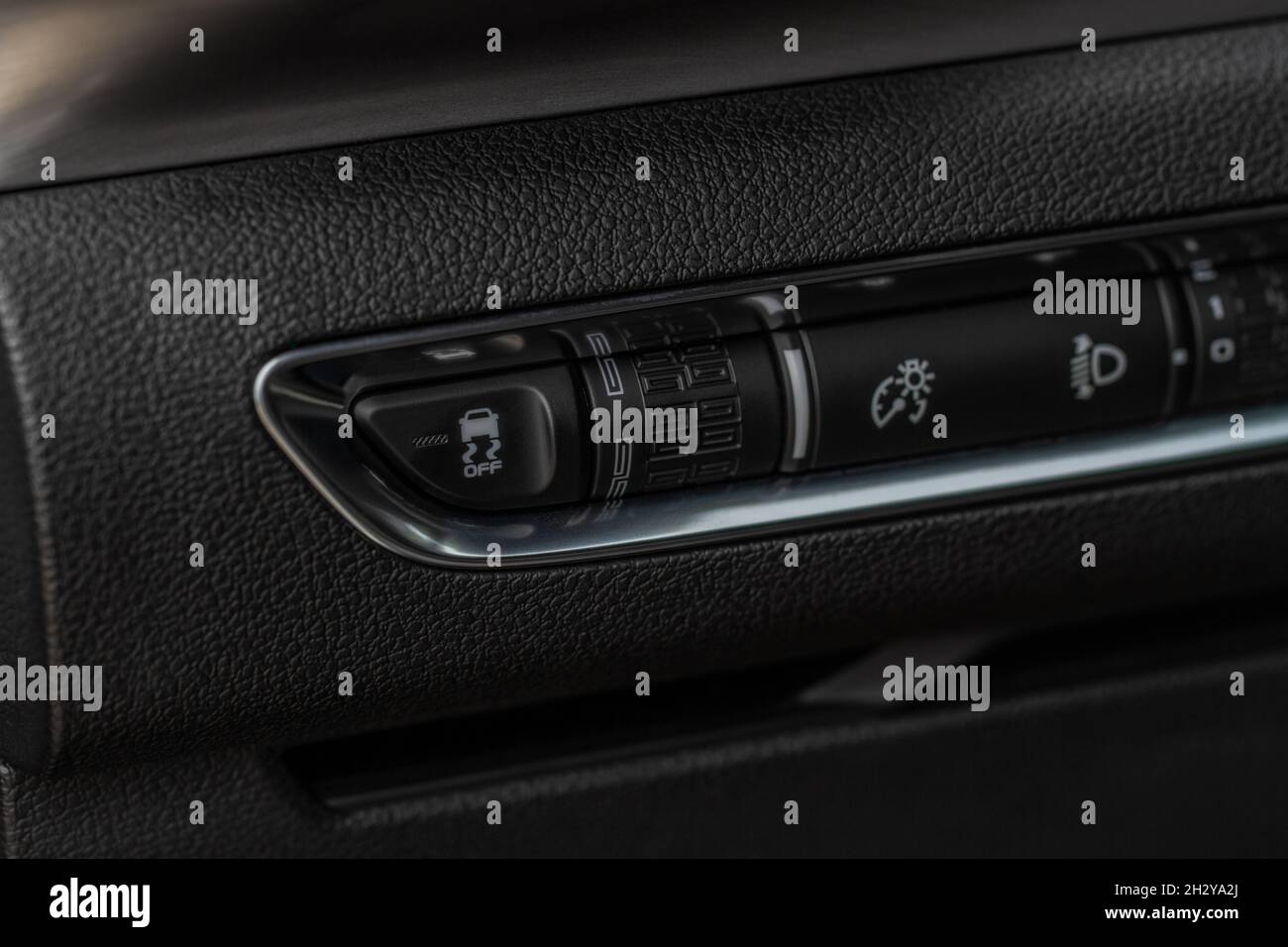 Hand operating ESP (electronic stability program) control close up view ...