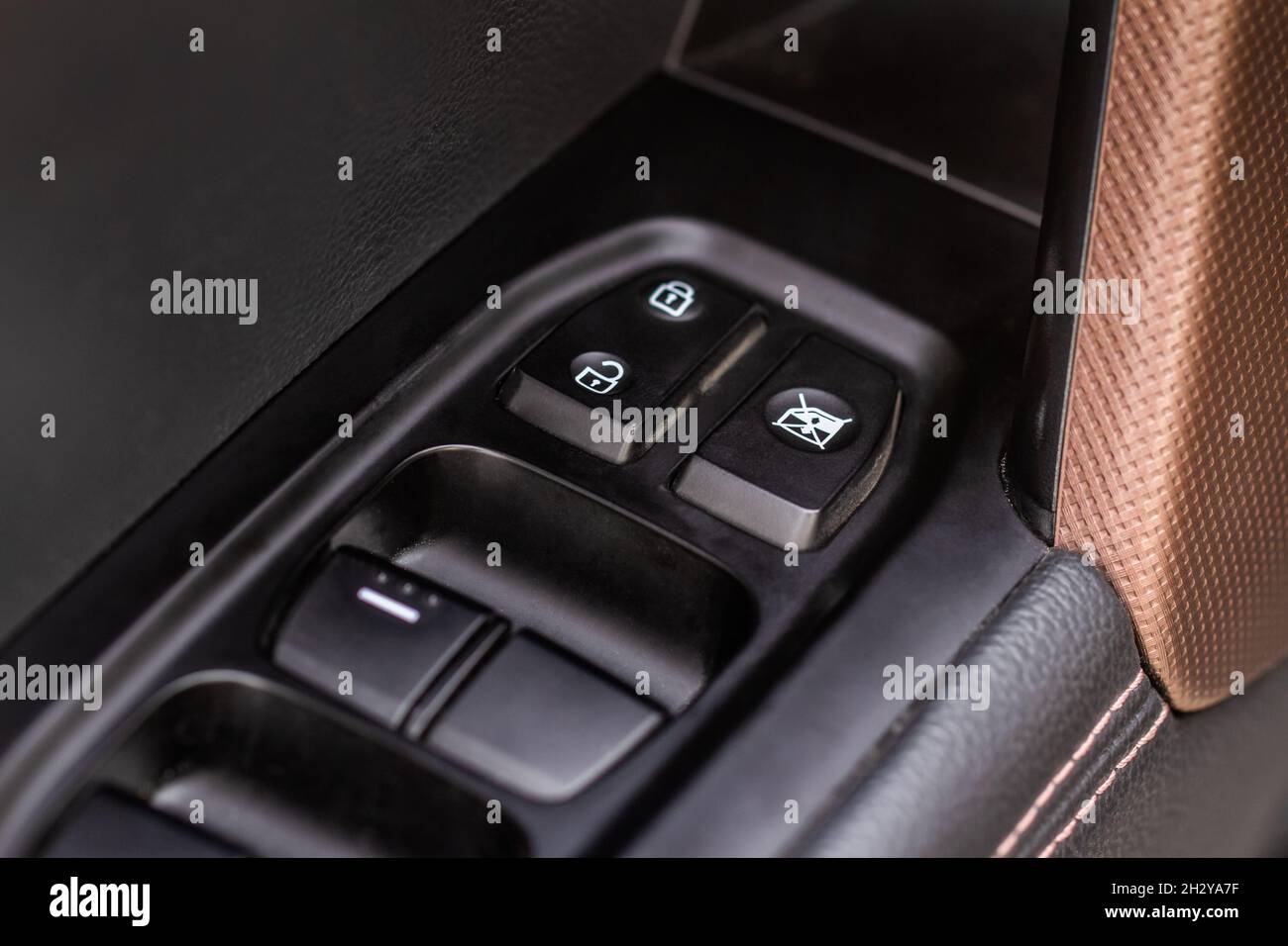 Close up view of button controlling window in modern car interior ...