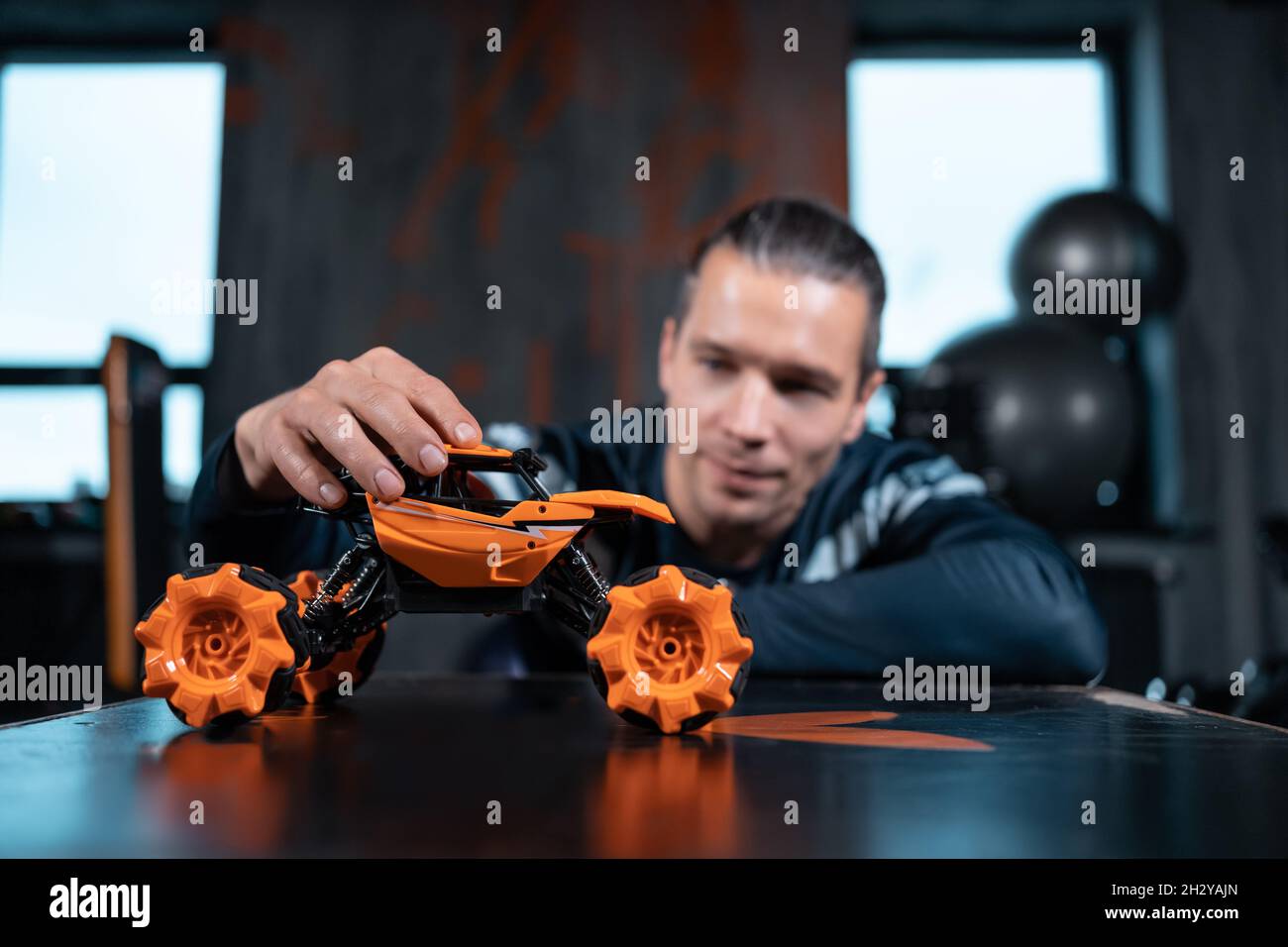 young man play with toy car and expressing inner child Stock Photo - Alamy