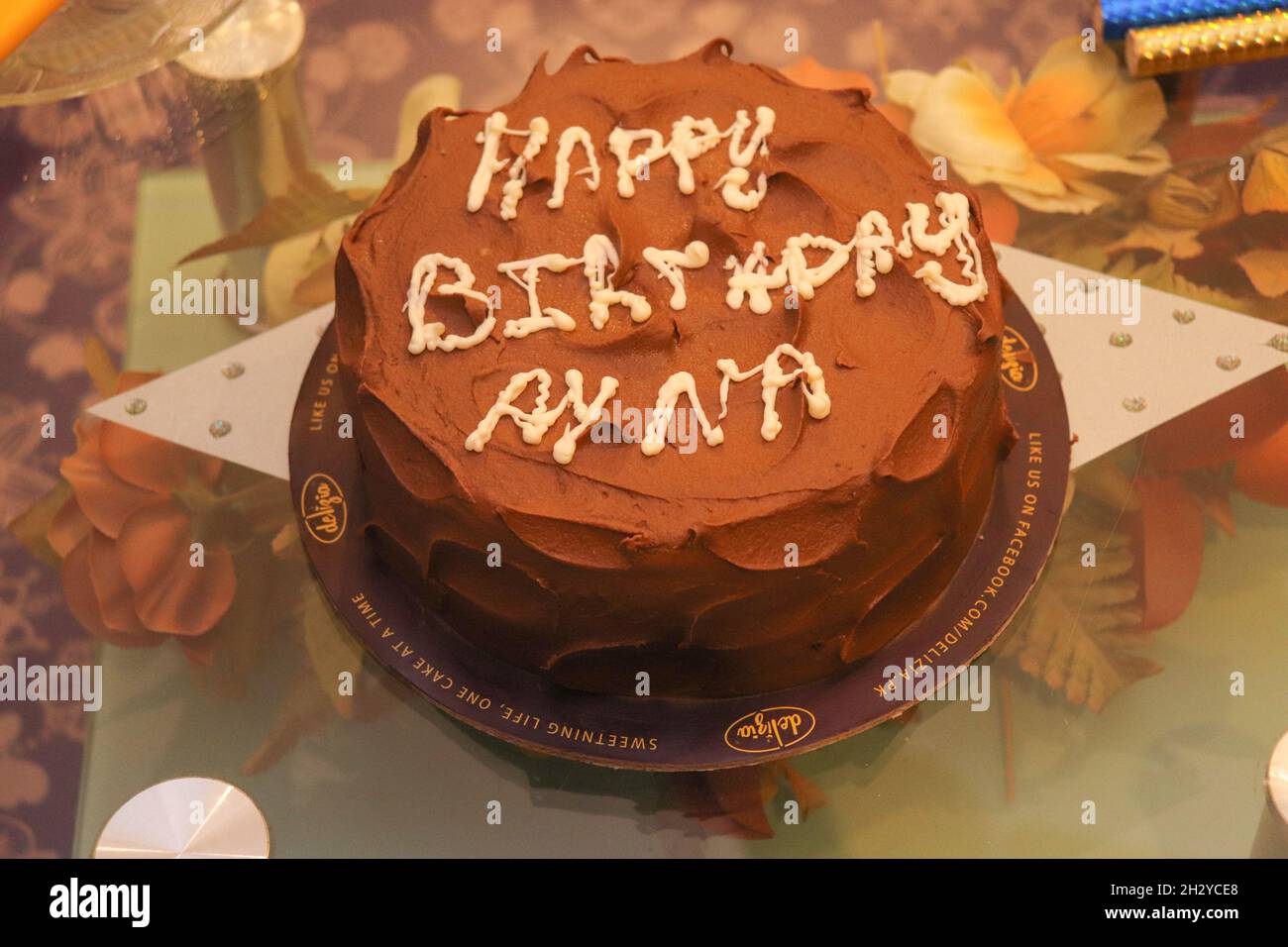 A tasty chocolate birthday cake with a white flavour writing on top ...