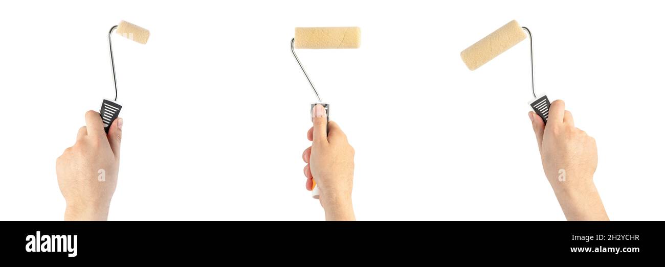 Paint roller in a man's hand. Renovation concept. Supplies and tools ...