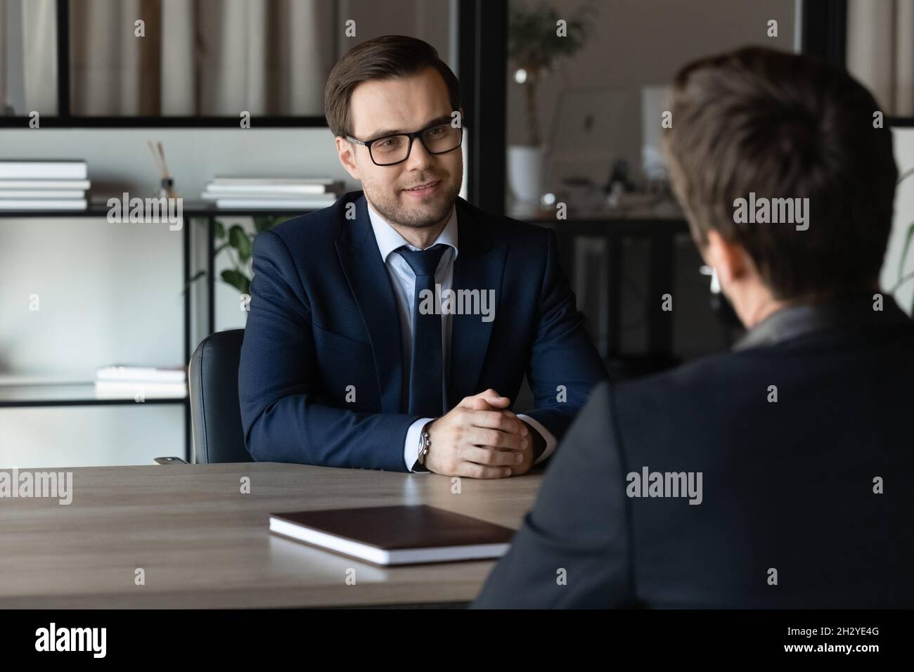 Young businessman job seeker sit at desk talk to recruiter Stock Photo ...