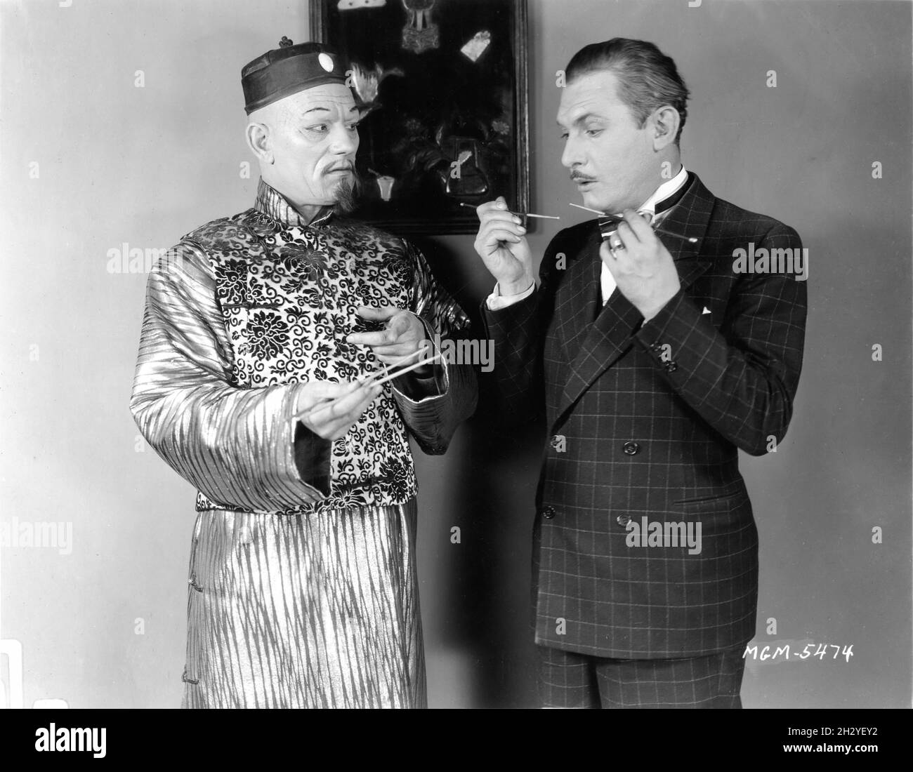 LON CHANEY in costume as Mr. Wu on set candid with MGM star LEW CODY ...