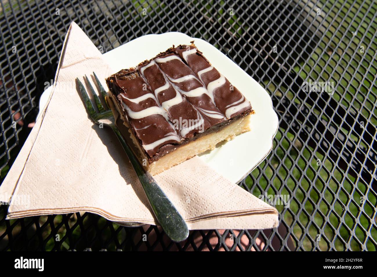 A slice of Millionaire's shortbread isloated on plate with fork. Also ...