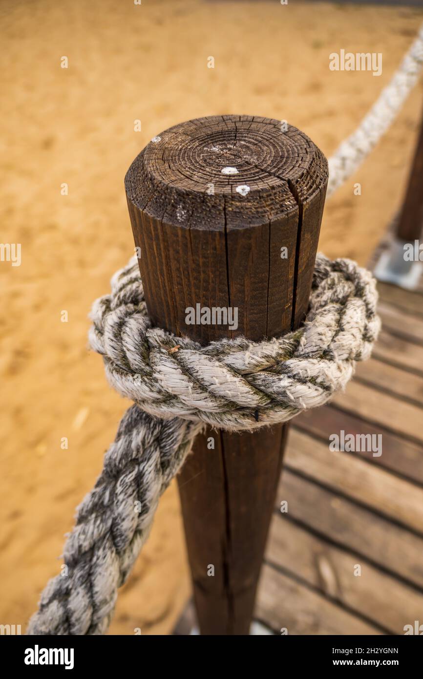 A vertical shot of a rope knot on a wooden stick Stock Photo - Alamy