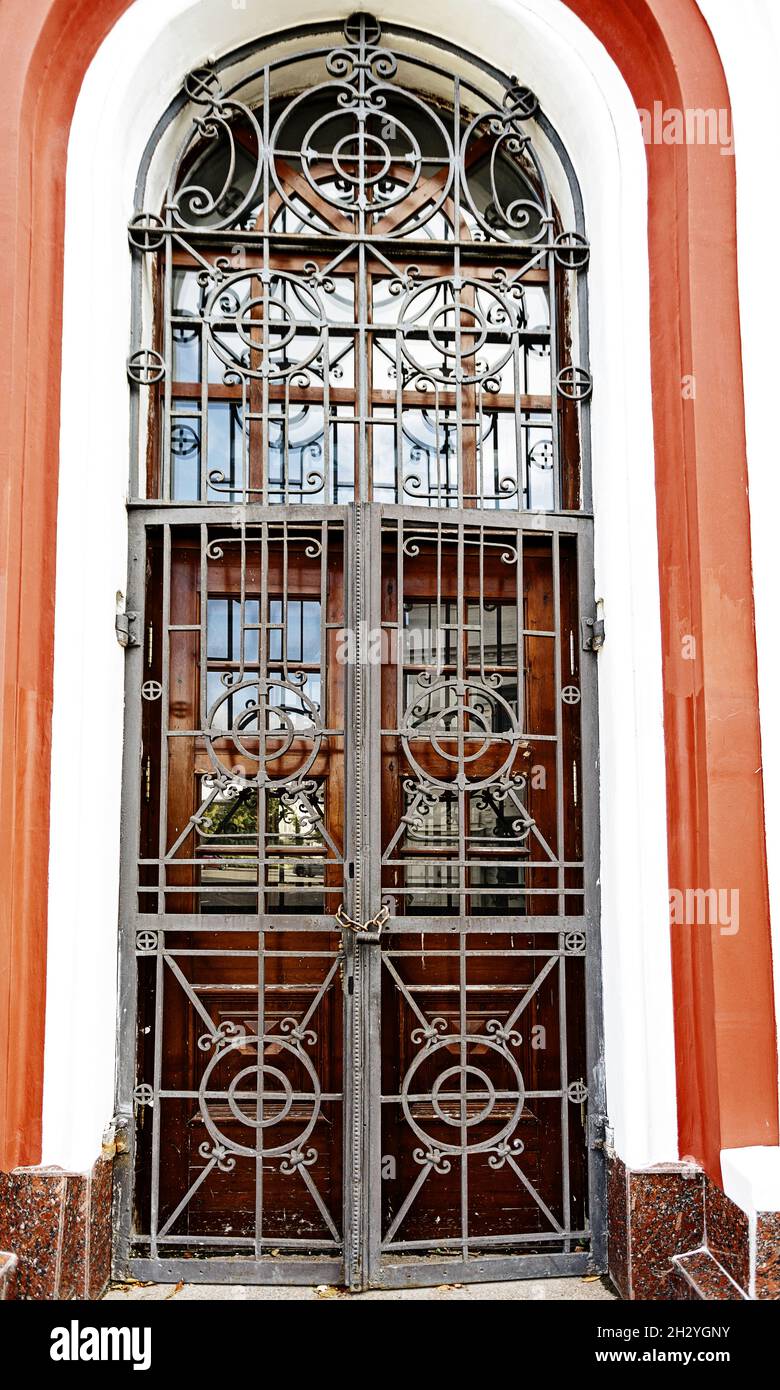 Close-up of a rusted gate. Antique cast iron gates closed with a lock ...