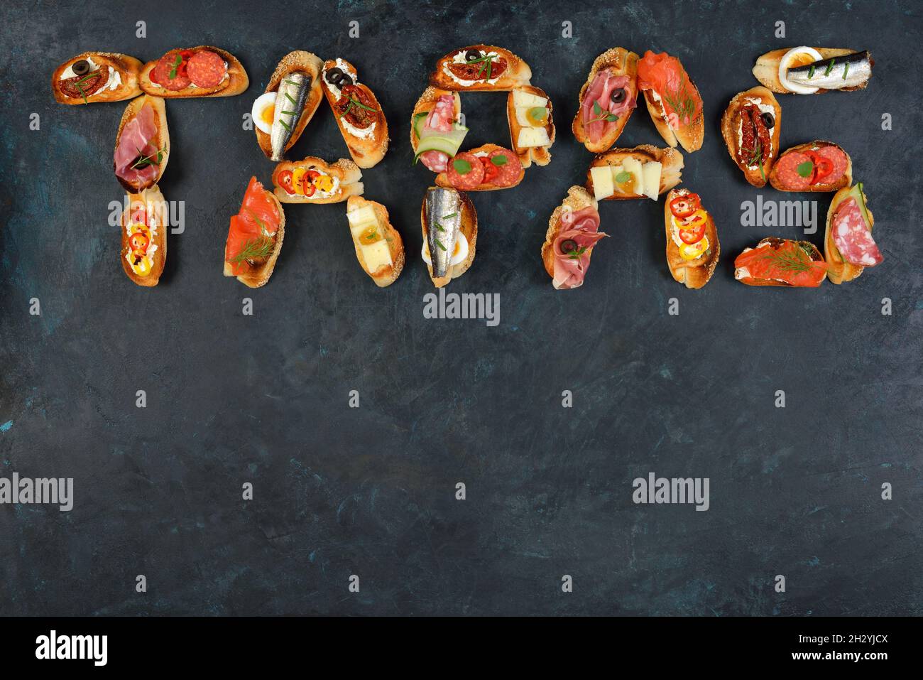 Mixed Spanish tapas with typical specialties on roasted baguette with ...