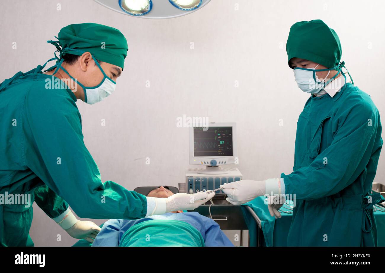 Doctor sending instrument with surgeon with rescue and save patient in ...