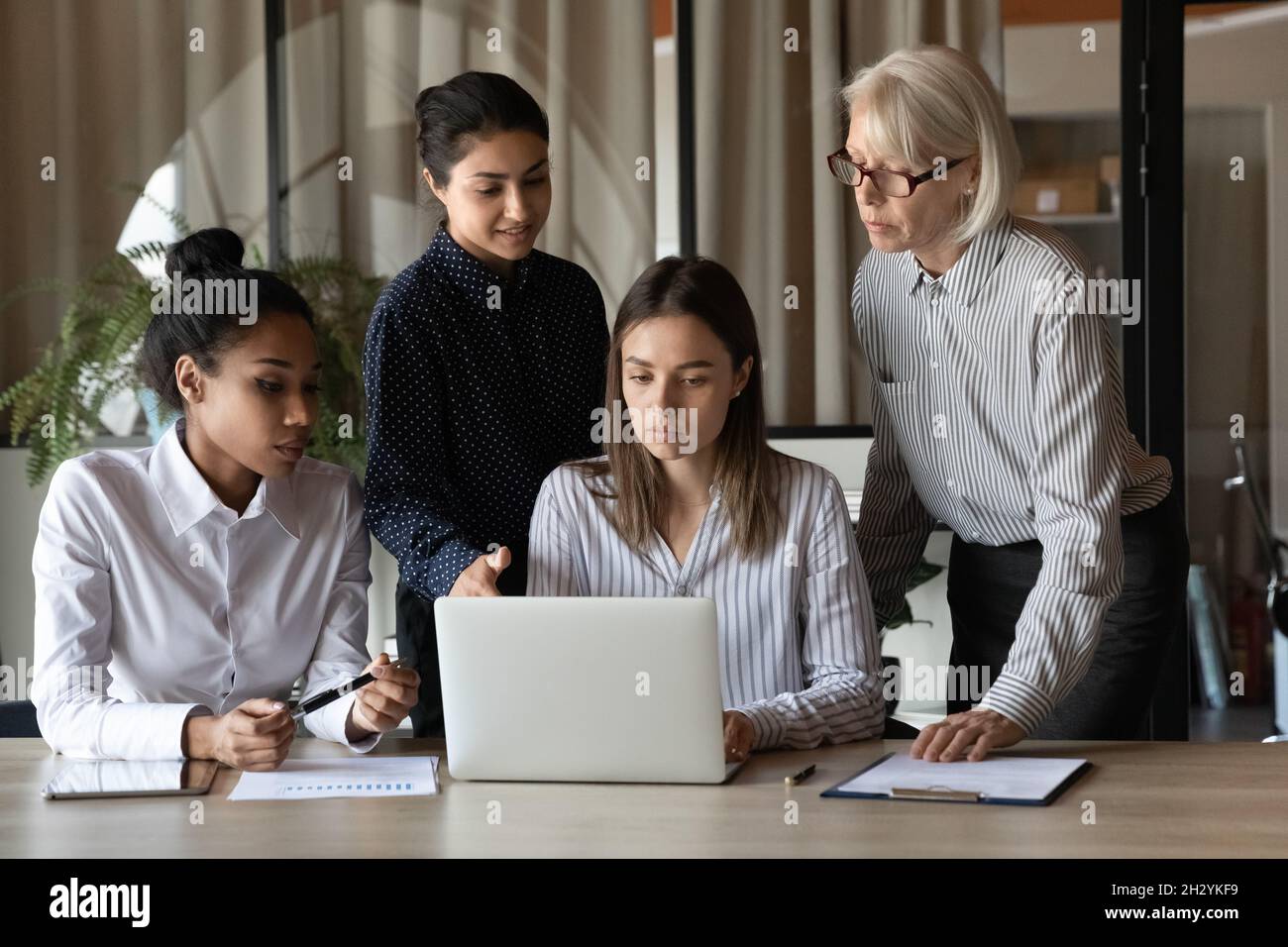 Indian woman manager discuss business idea with multiracial female ...