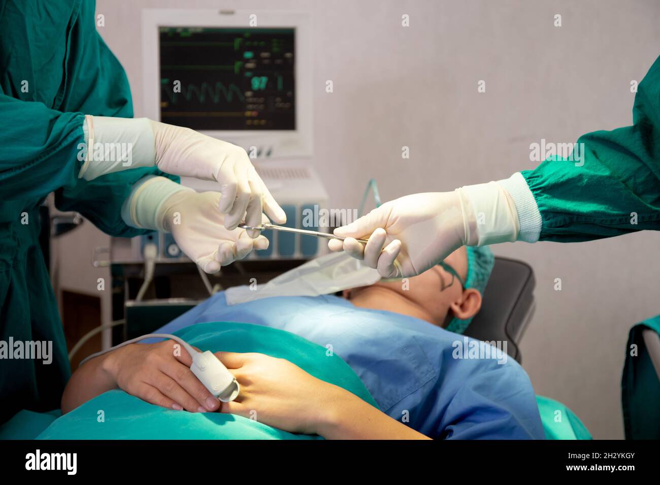 Closeup hands of doctor sending instrument with surgeon with rescue and ...