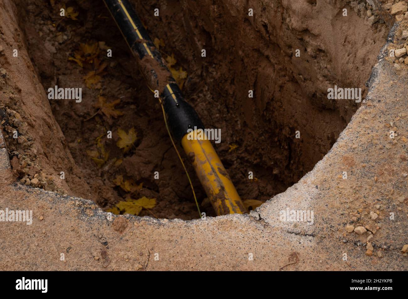 An outcrop showing a metal communication pipe during road construction ...
