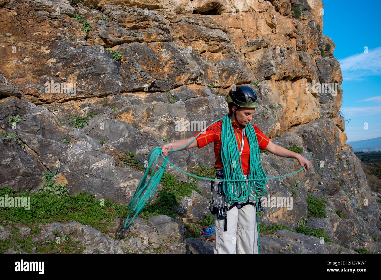 Female rock climber coiling the rope Stock Photo - Alamy