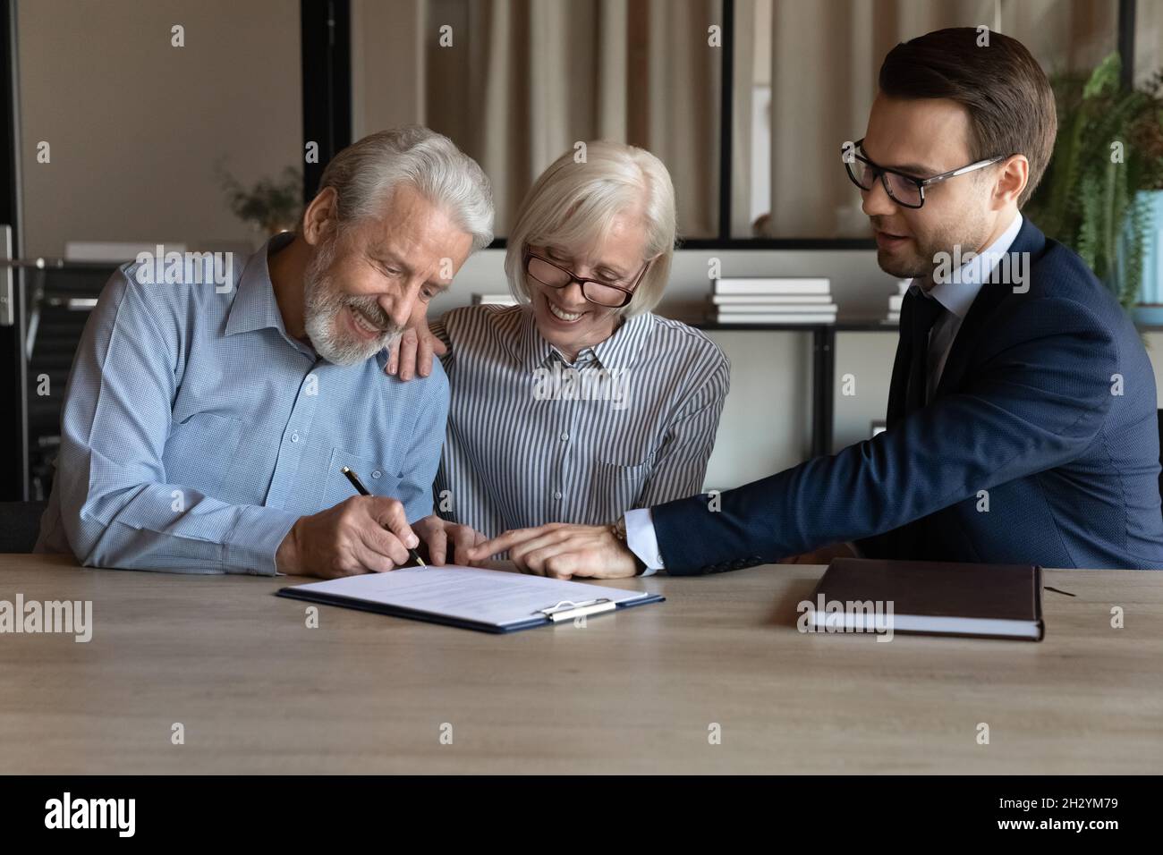 Satisfied husband wife retirees put signatures under life insurance ...