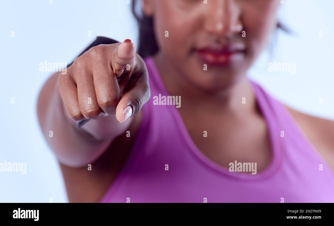 A young female in a sports outfit pointing with her finger Stock Photo ...