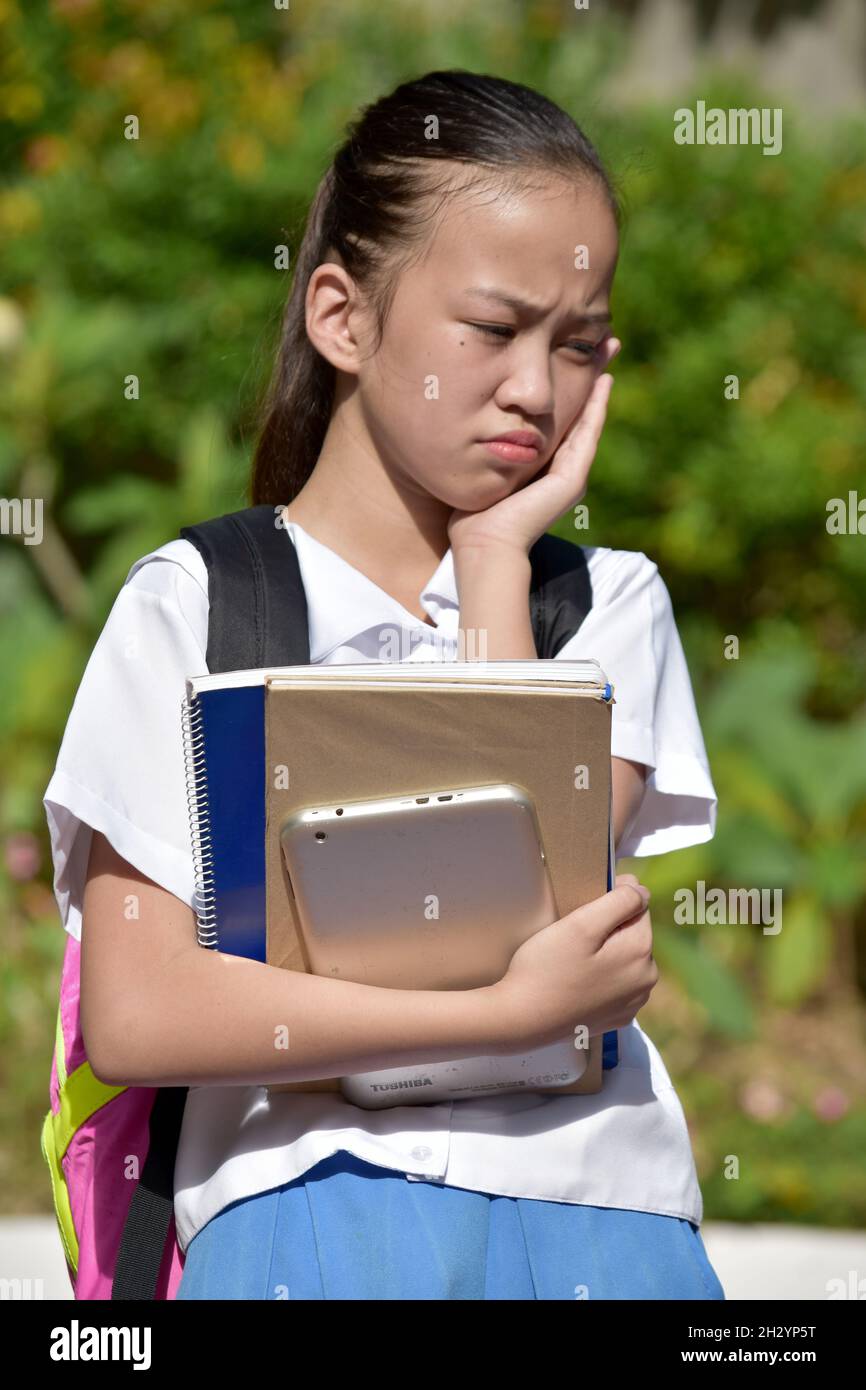Female Student And Sadness Wearing Uniform With Notebooks Stock Photo ...