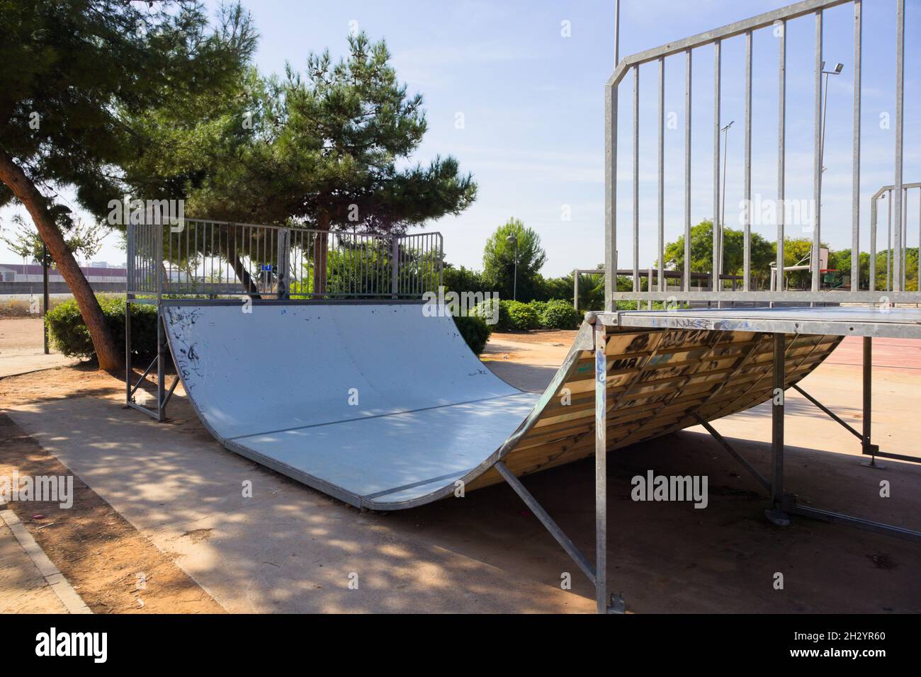 Close-up of a skatepark ramp in a public park that is outdoors and ...
