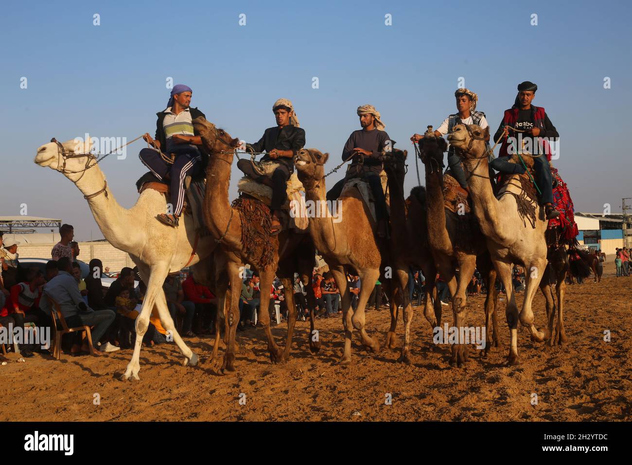 Gaza. 24th Oct, 2021. Palestinian jockeys ride camels as they take part ...