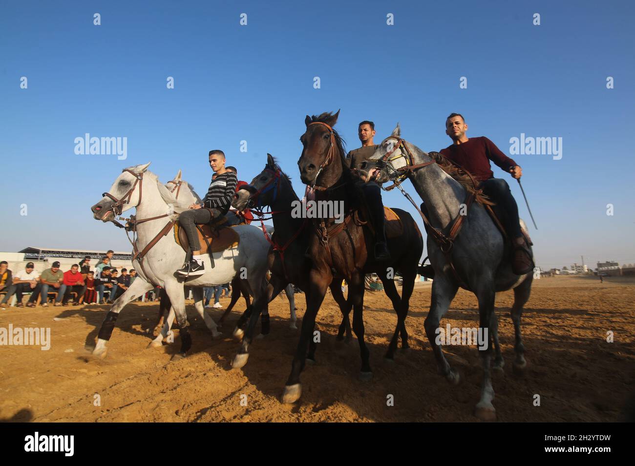 Gaza. 24th Oct, 2021. Palestinian jockeys ride horses as they take part ...